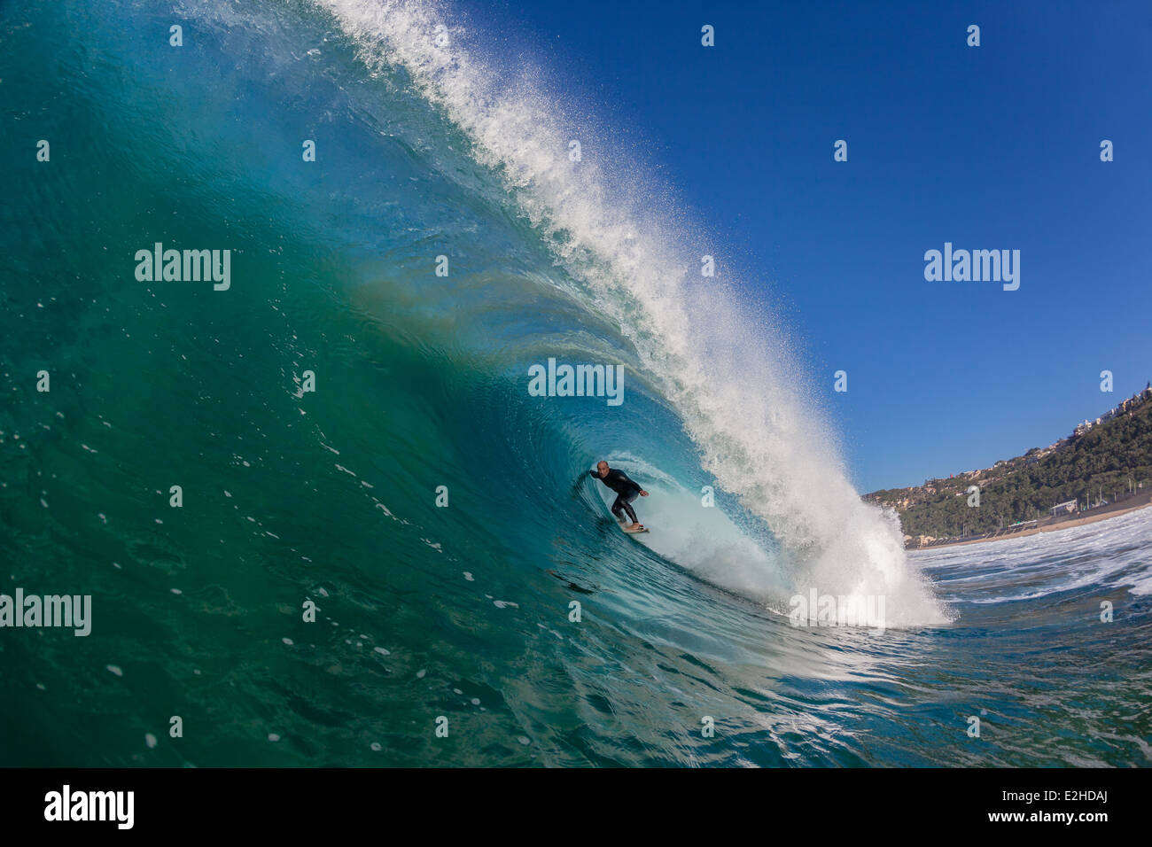 Surfer surfing rides Inside large hollow tubing crashing wave a ...