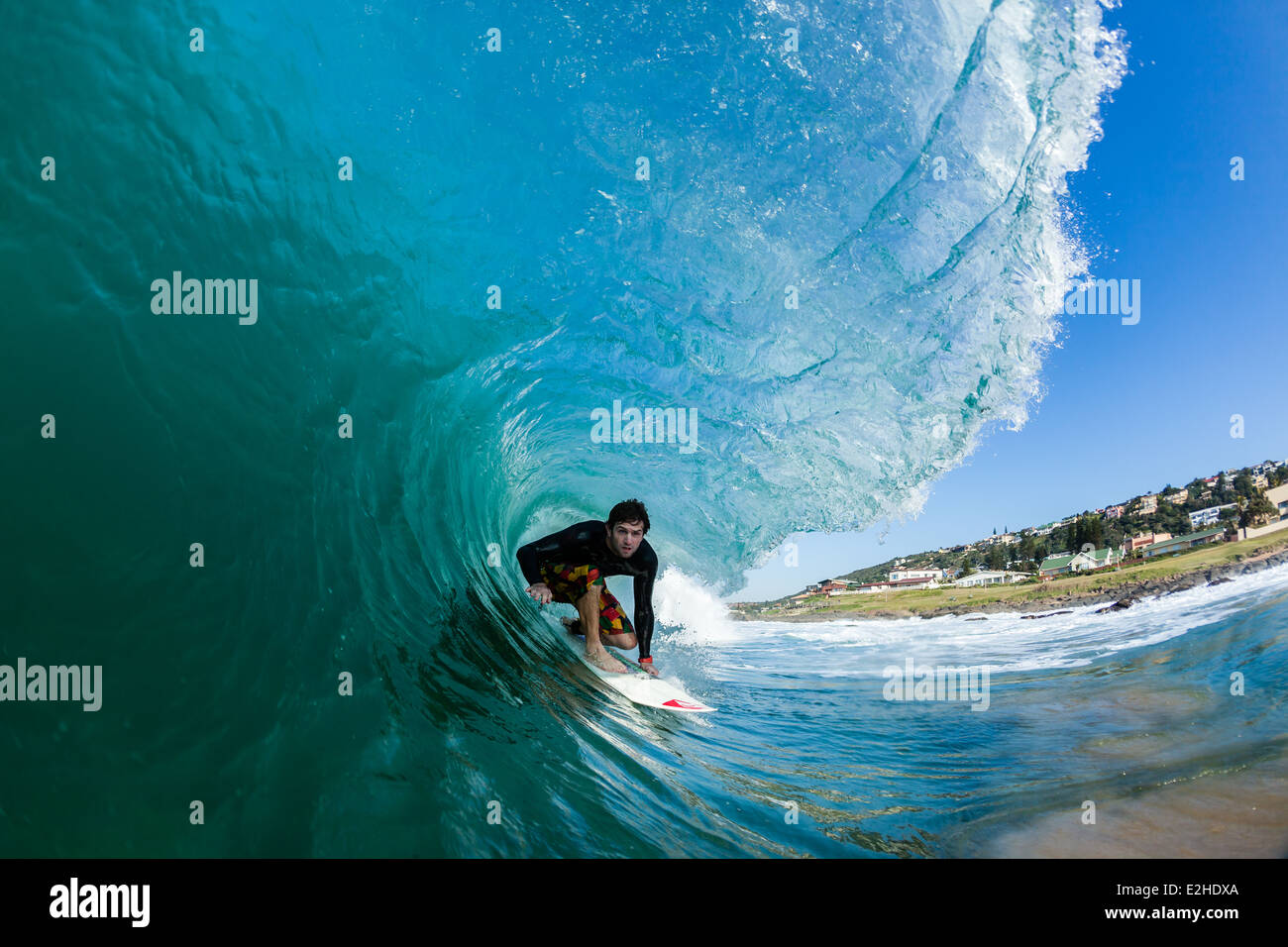 Surfer surfing inside hollow ocean wave closeup swimming water action ...