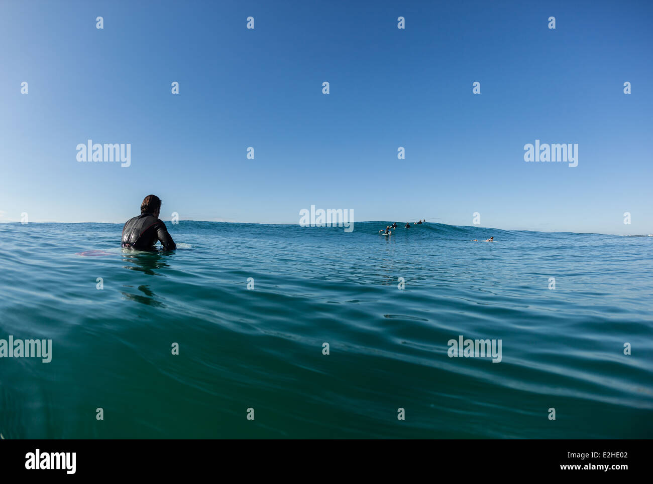 Surfer surfing unidentified rear swimming water photo waiting for ocean ...