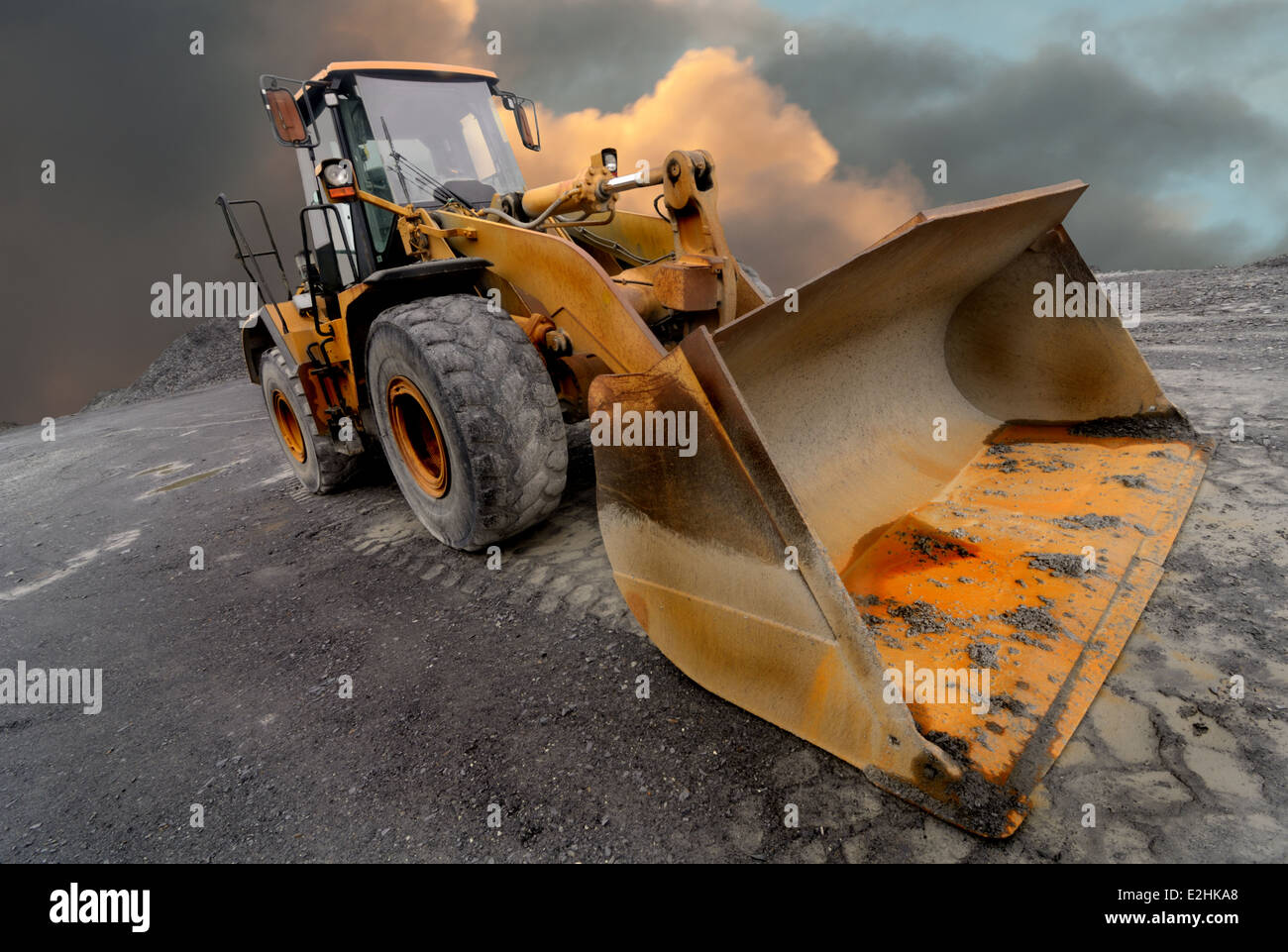Image of a quarry Loader / excavator with a dramatic sky background ...