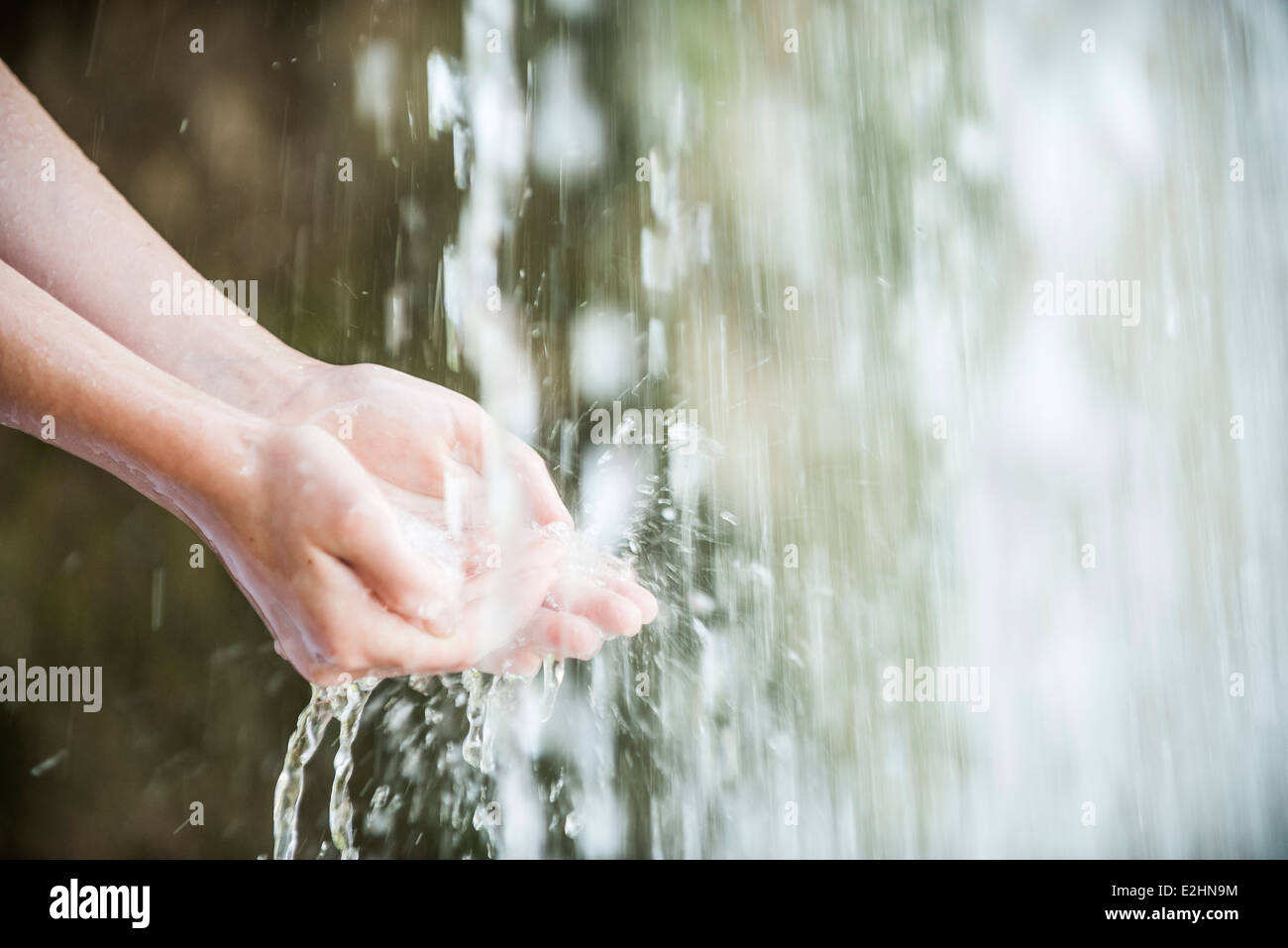 Child holding hands under waterfall, cropped Stock Photo - Alamy