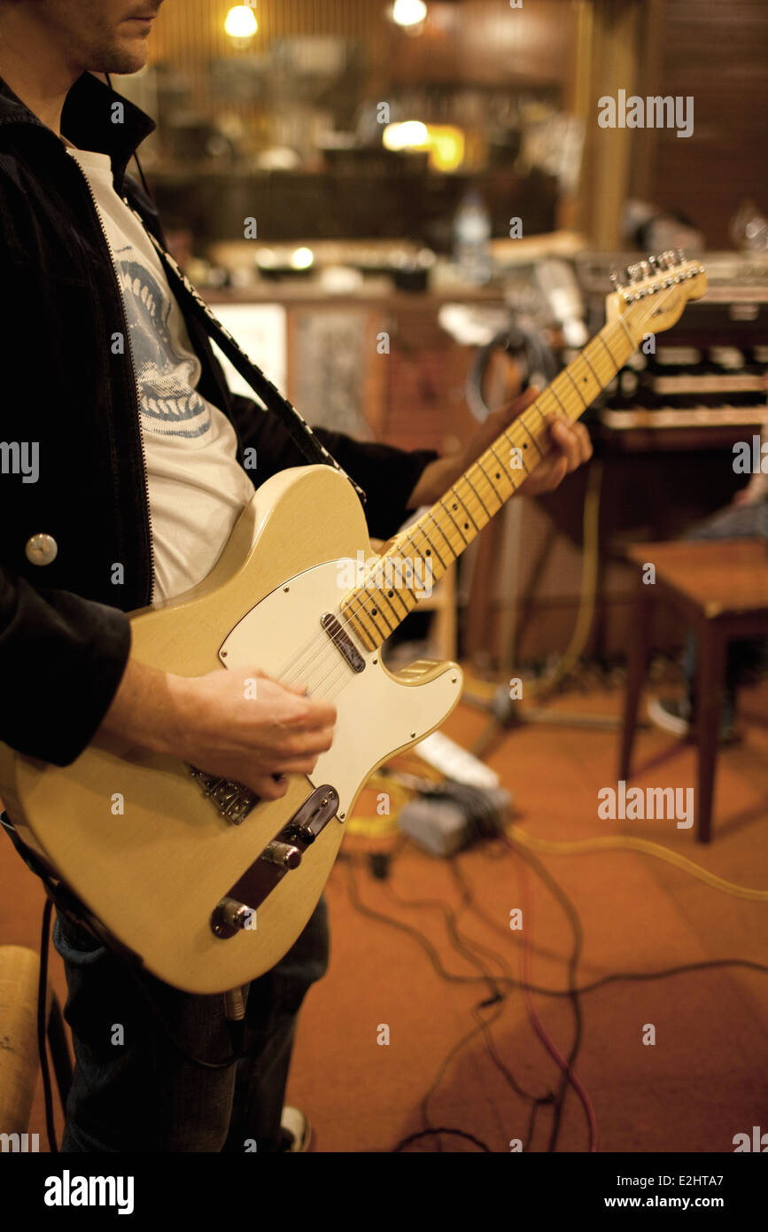 Man playing electric guitar in studio Stock Photo - Alamy