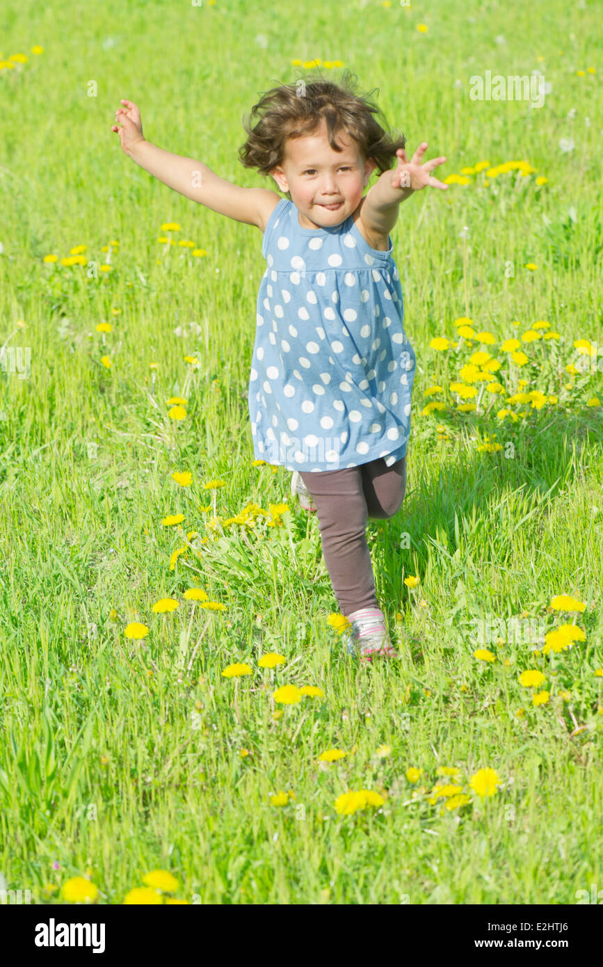 Little girl running in meadow Stock Photo - Alamy