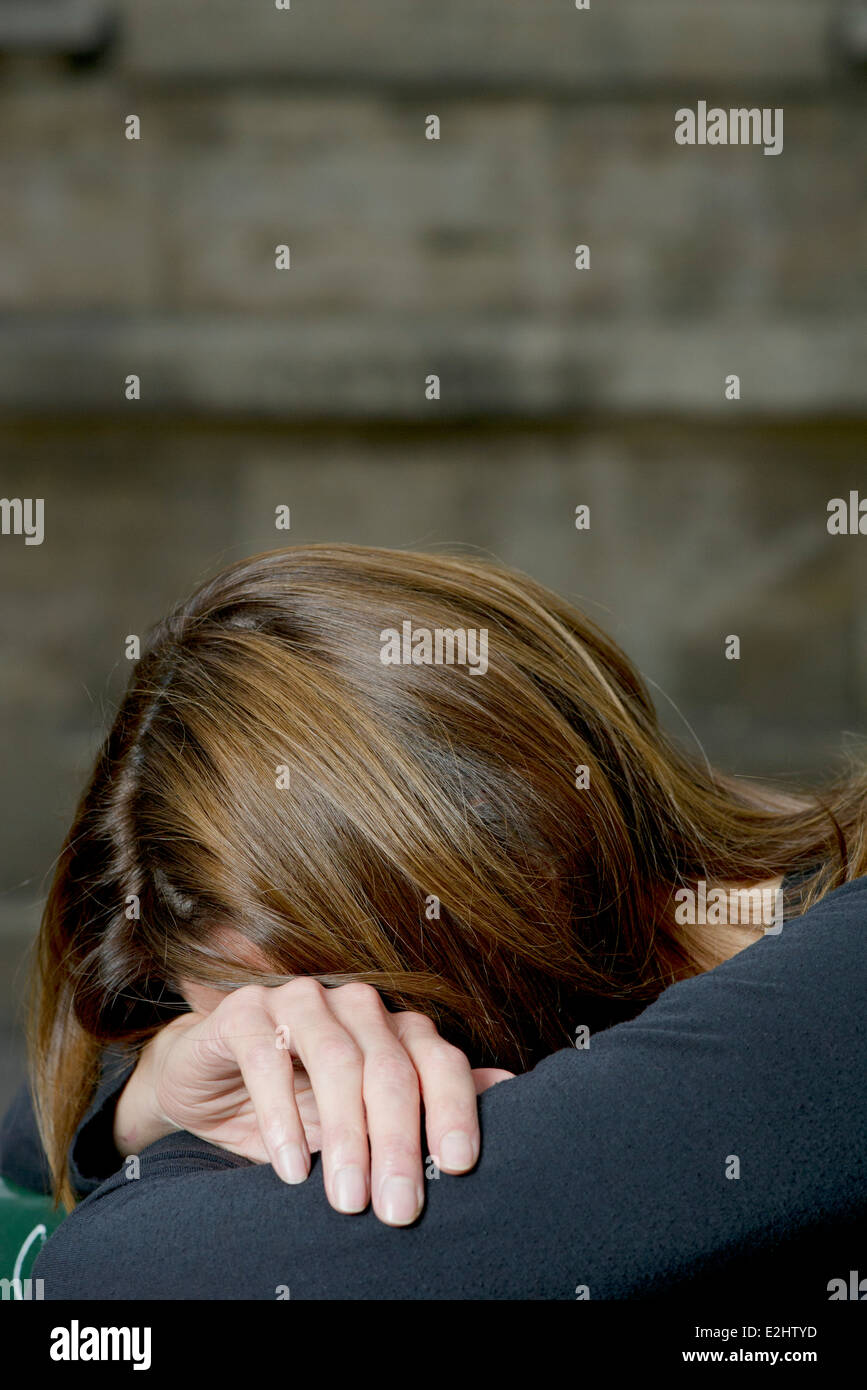 Woman resting head on arms Stock Photo - Alamy