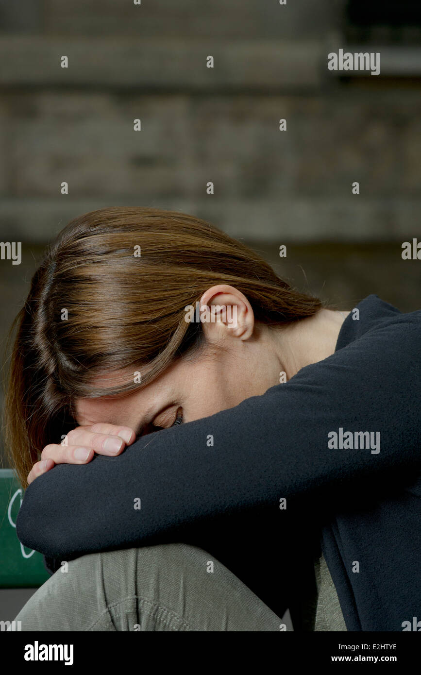 Woman resting head on arms Stock Photo - Alamy