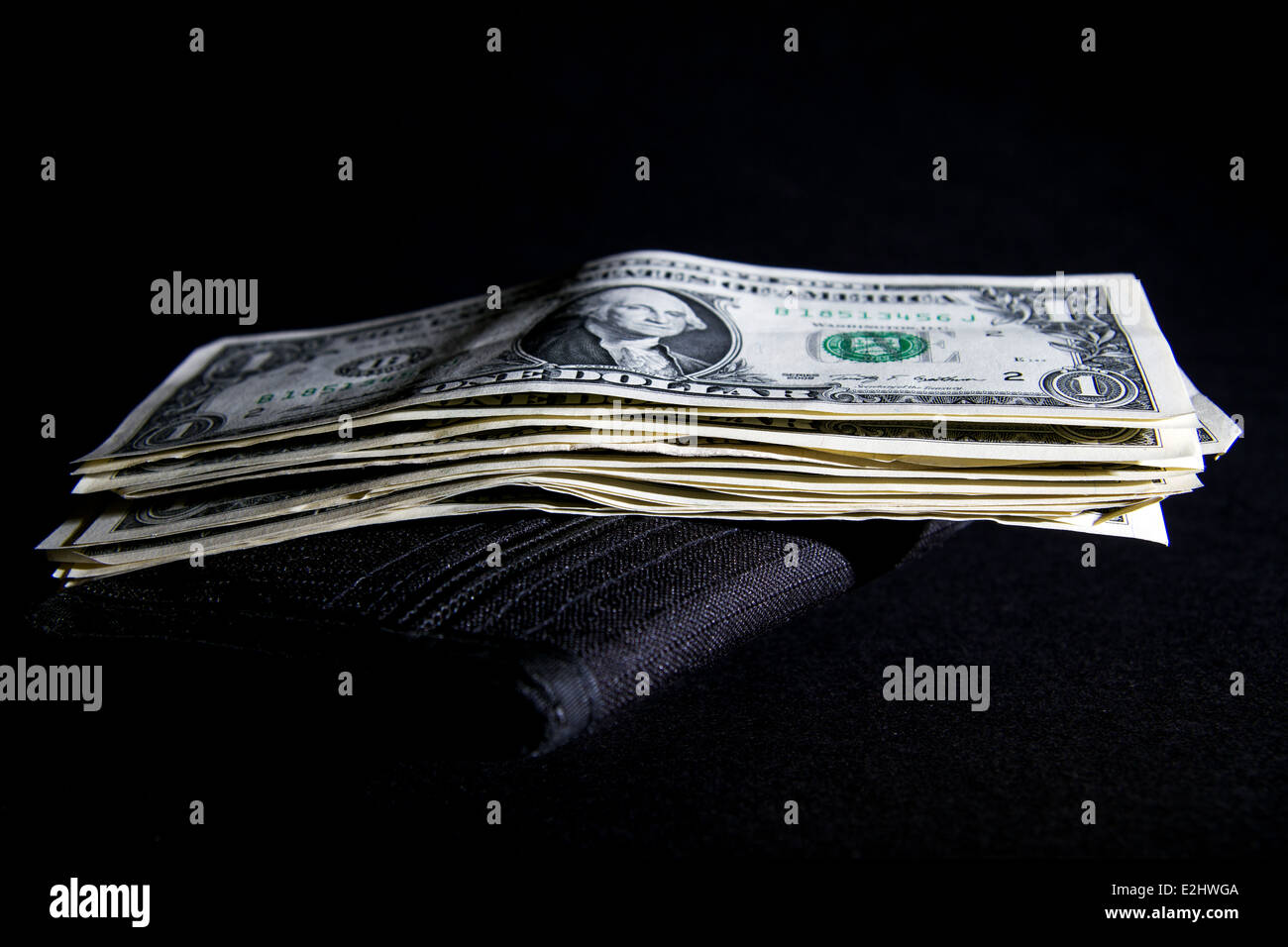 Pile of American one dollar bills on top of a black wallet Stock Photo ...