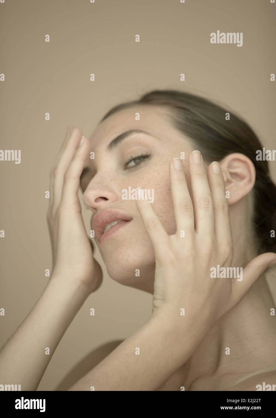 Woman with hands around face, portrait Stock Photo - Alamy