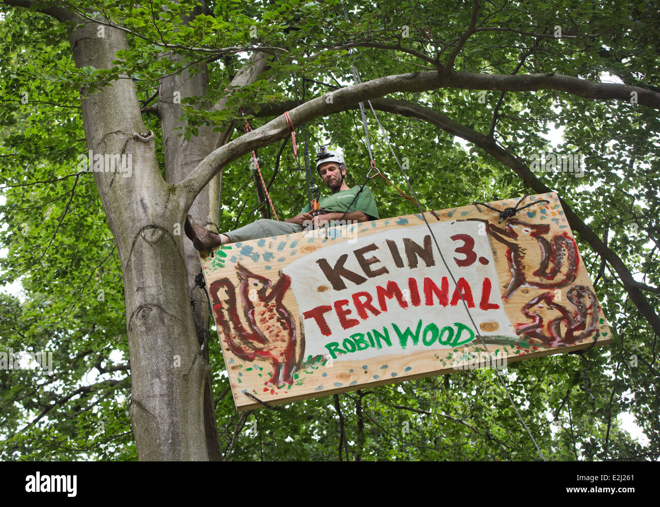 Trebur, Germany. 20th June, 2014. An activist of Robin Wood attaches a ...