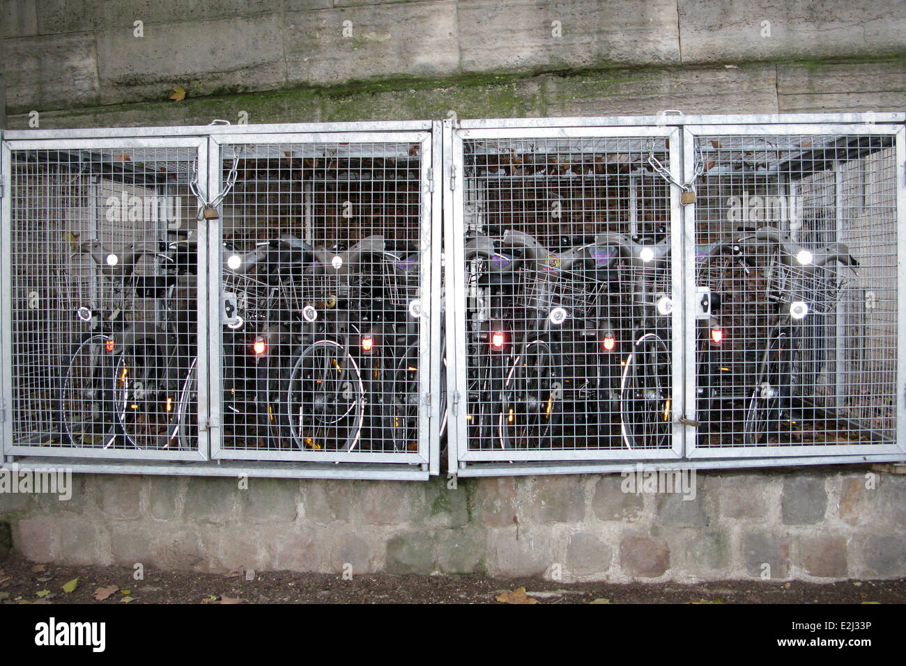 Rental bicycles locked up in storage cage Stock Photo - Alamy