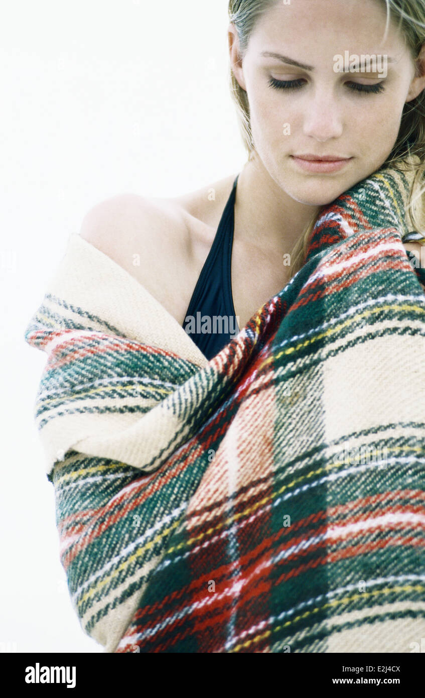 Young woman wrapped in blanket Stock Photo - Alamy