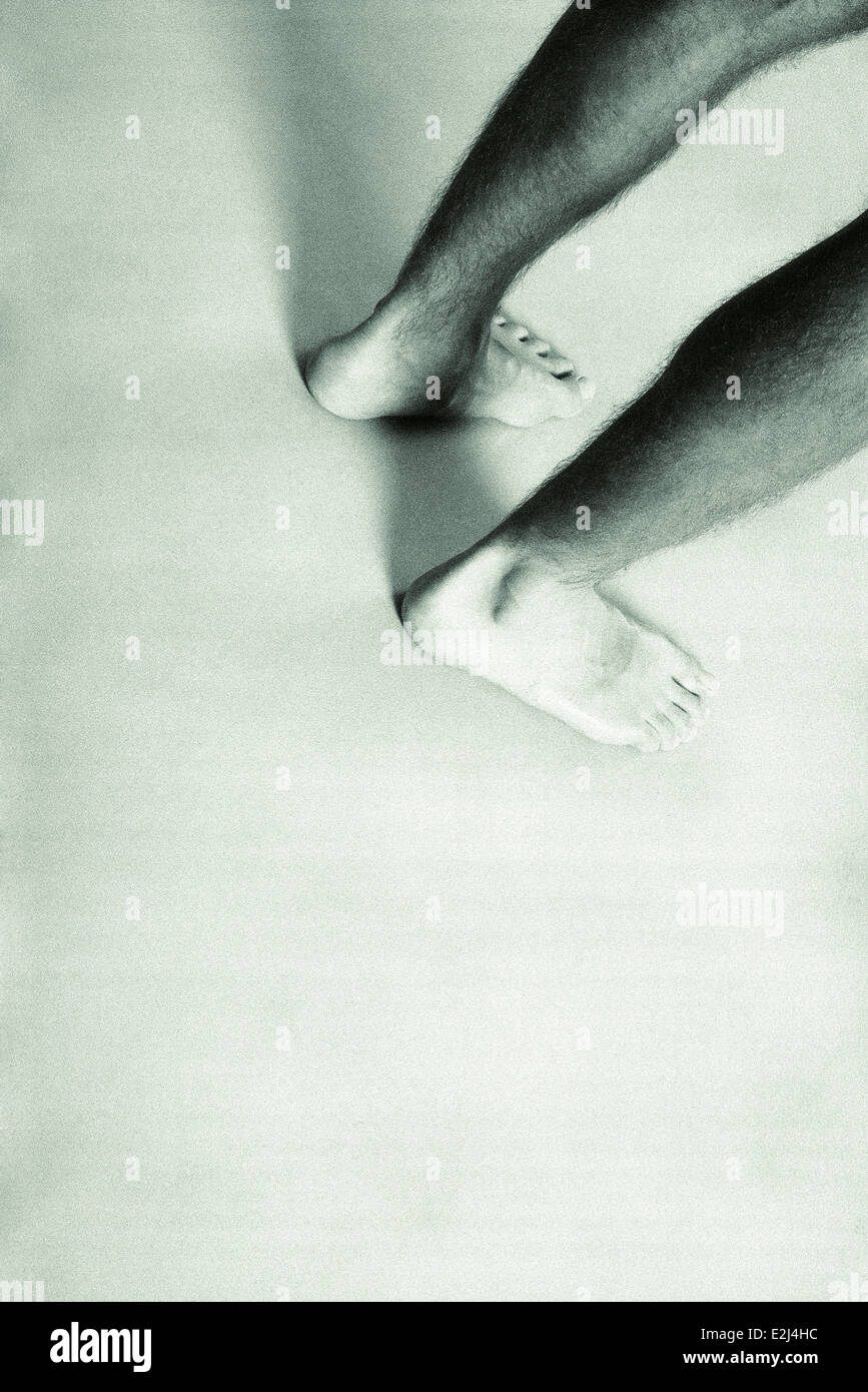 Man's legs and bare feet, cropped Stock Photo - Alamy