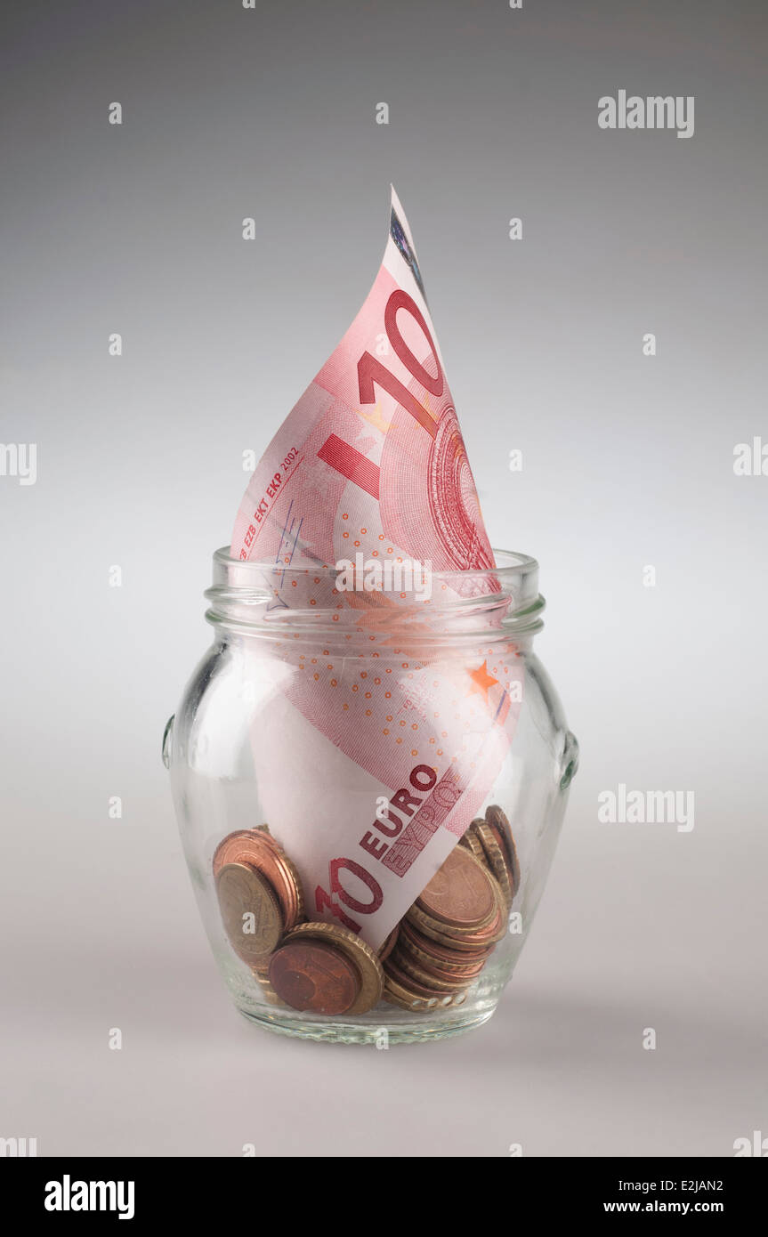 Cash in money jar hi-res stock photography and images - Alamy