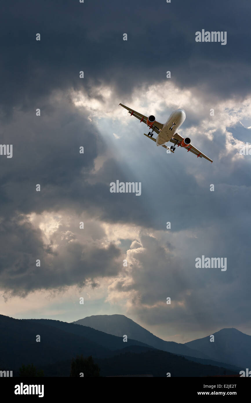 Passenger plane on final approach, against a stormy sky Stock Photo - Alamy