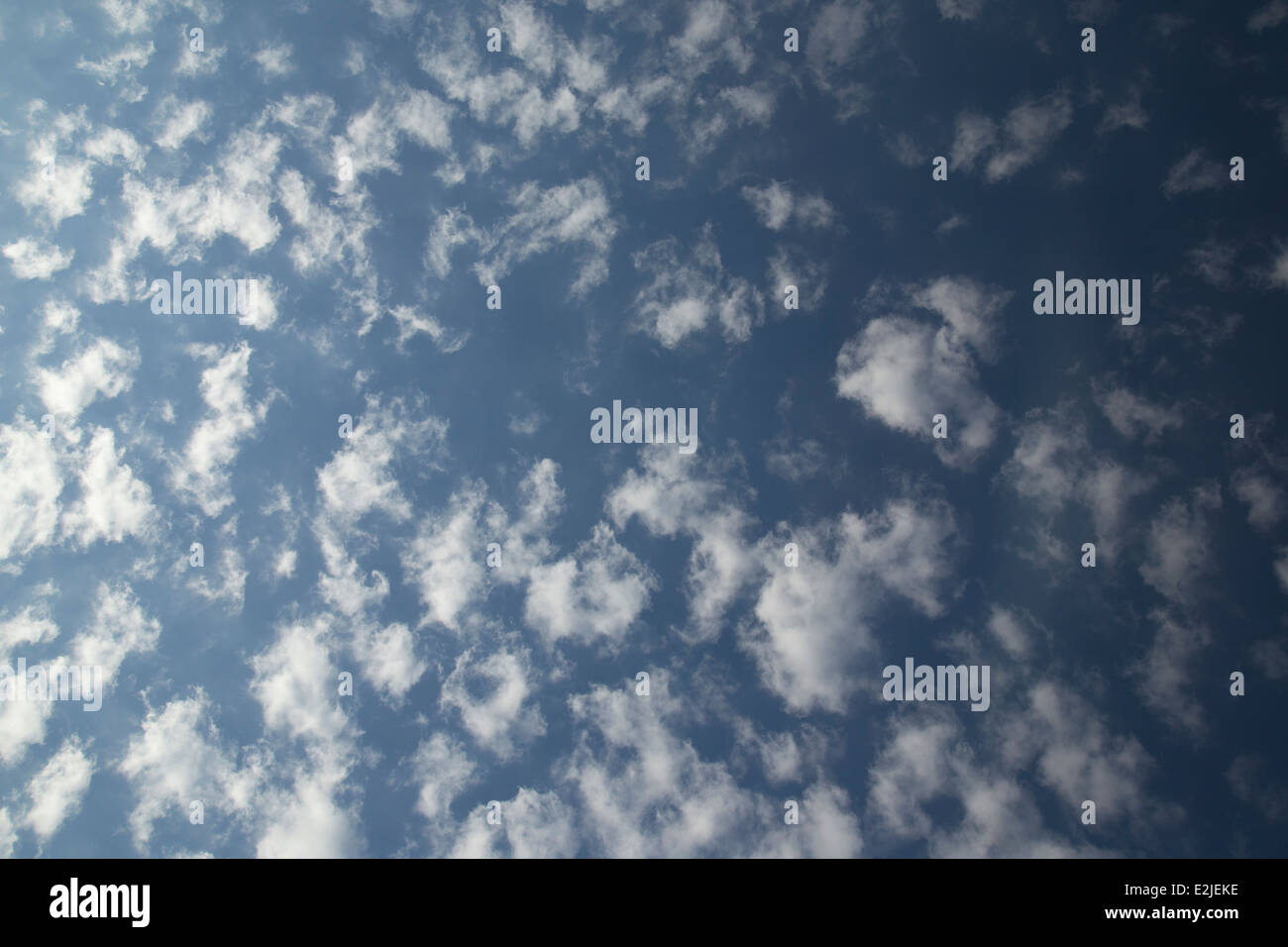 Blue sky with small white clouds Stock Photo - Alamy