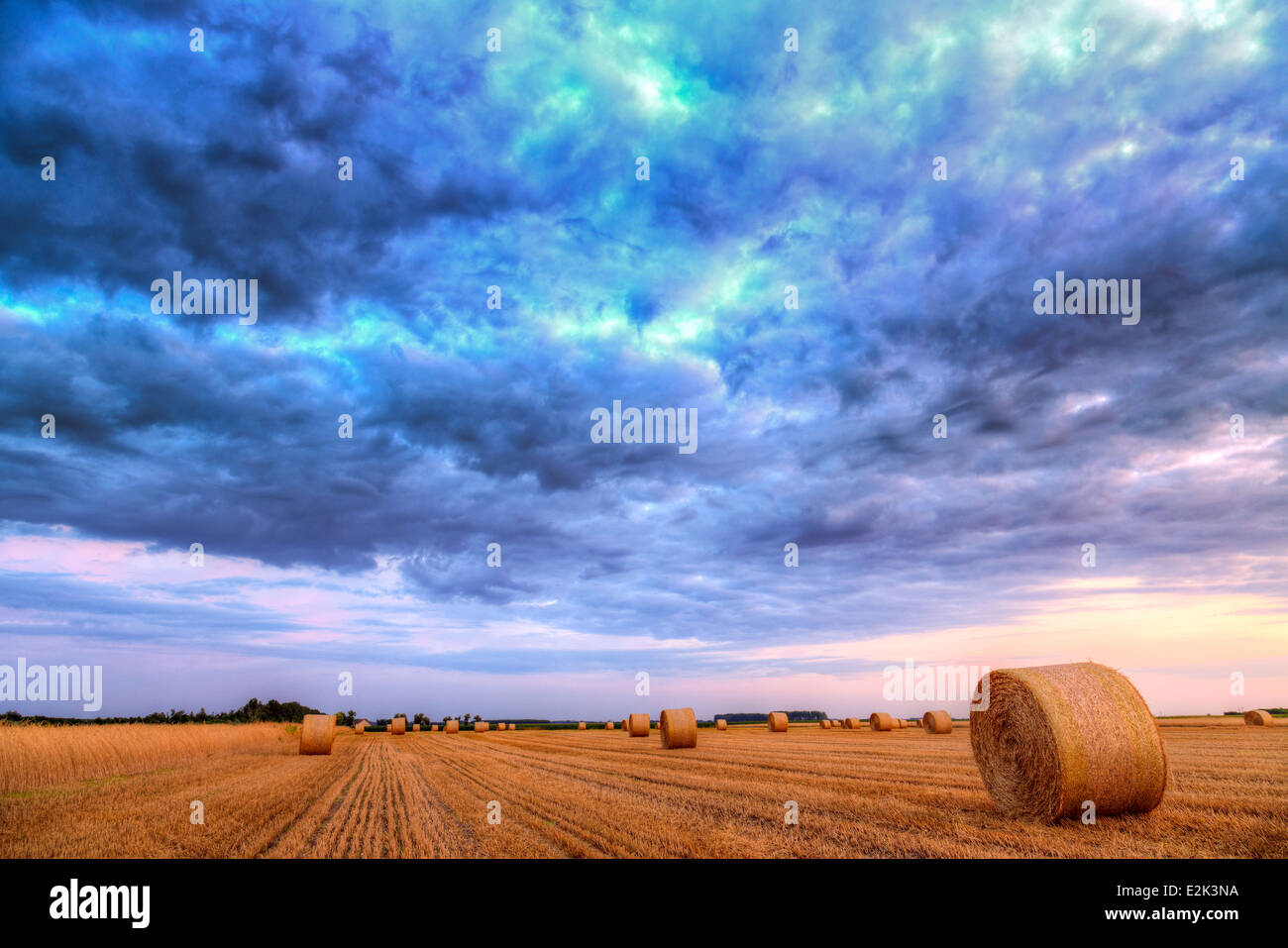 Sunset over farm field with hay bales Stock Photo - Alamy