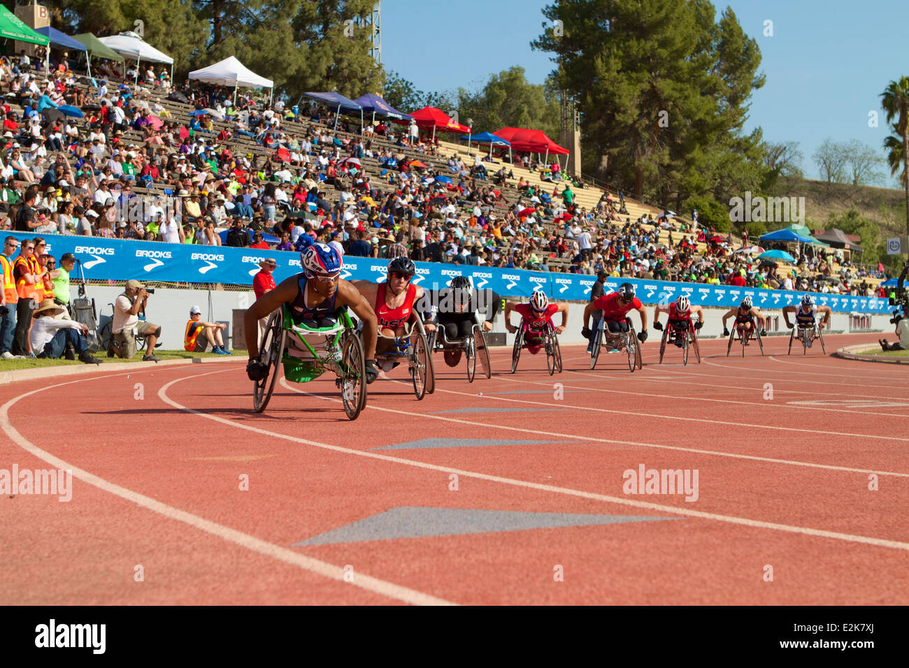 Competitors line up at the start of a wheelchair race on the track at ...