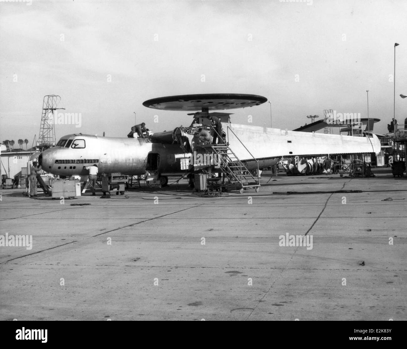 This image shows a Grumman E-2A Hawkeye undergoing outdoor maintenance ...