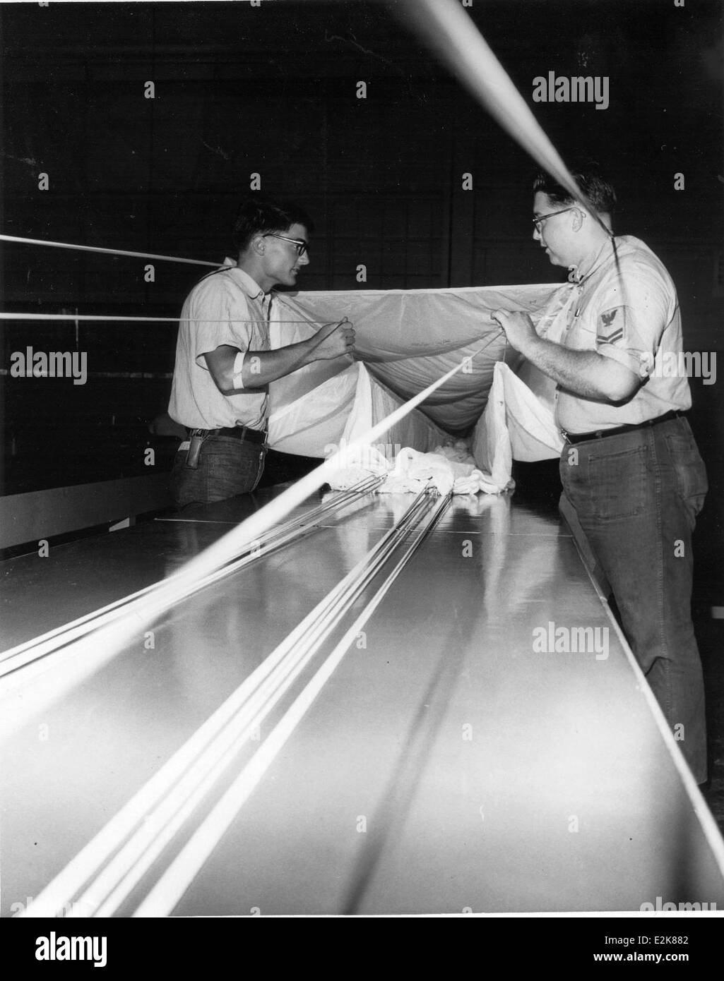 This image shows parachute riggers at NAS (Naval Air Station) NI ...