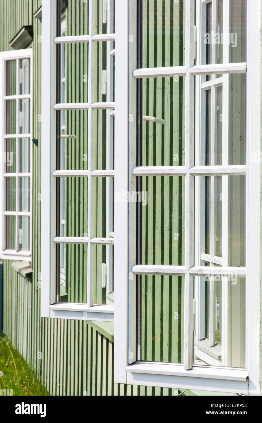 White wooden windows and green walls - traditional architecture in ...