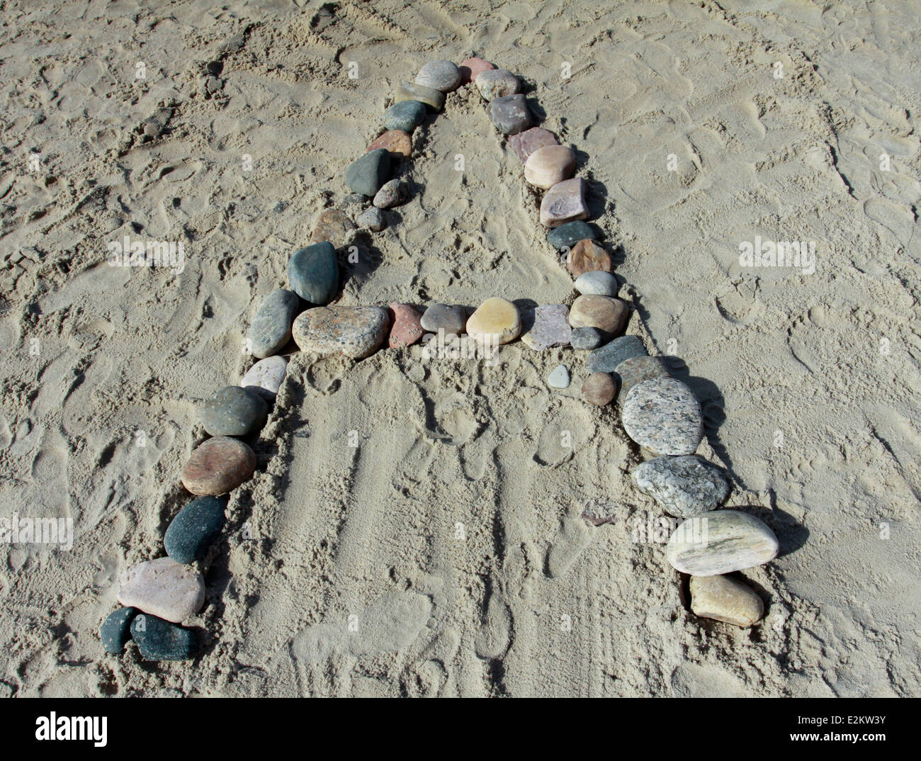 Letter A of stones on sandy beach Stock Photo - Alamy