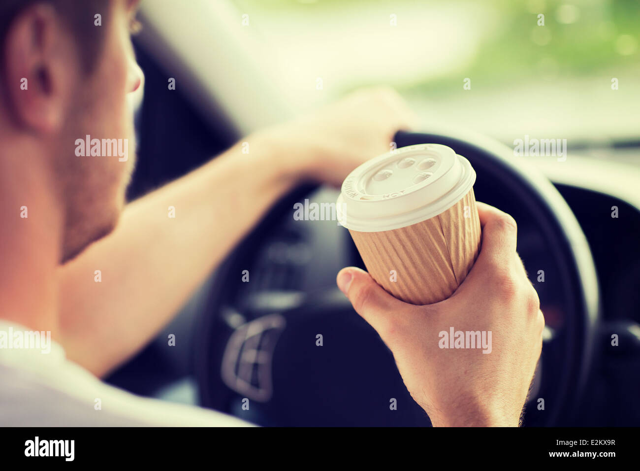 man drinking coffee while driving the car Stock Photo - Alamy