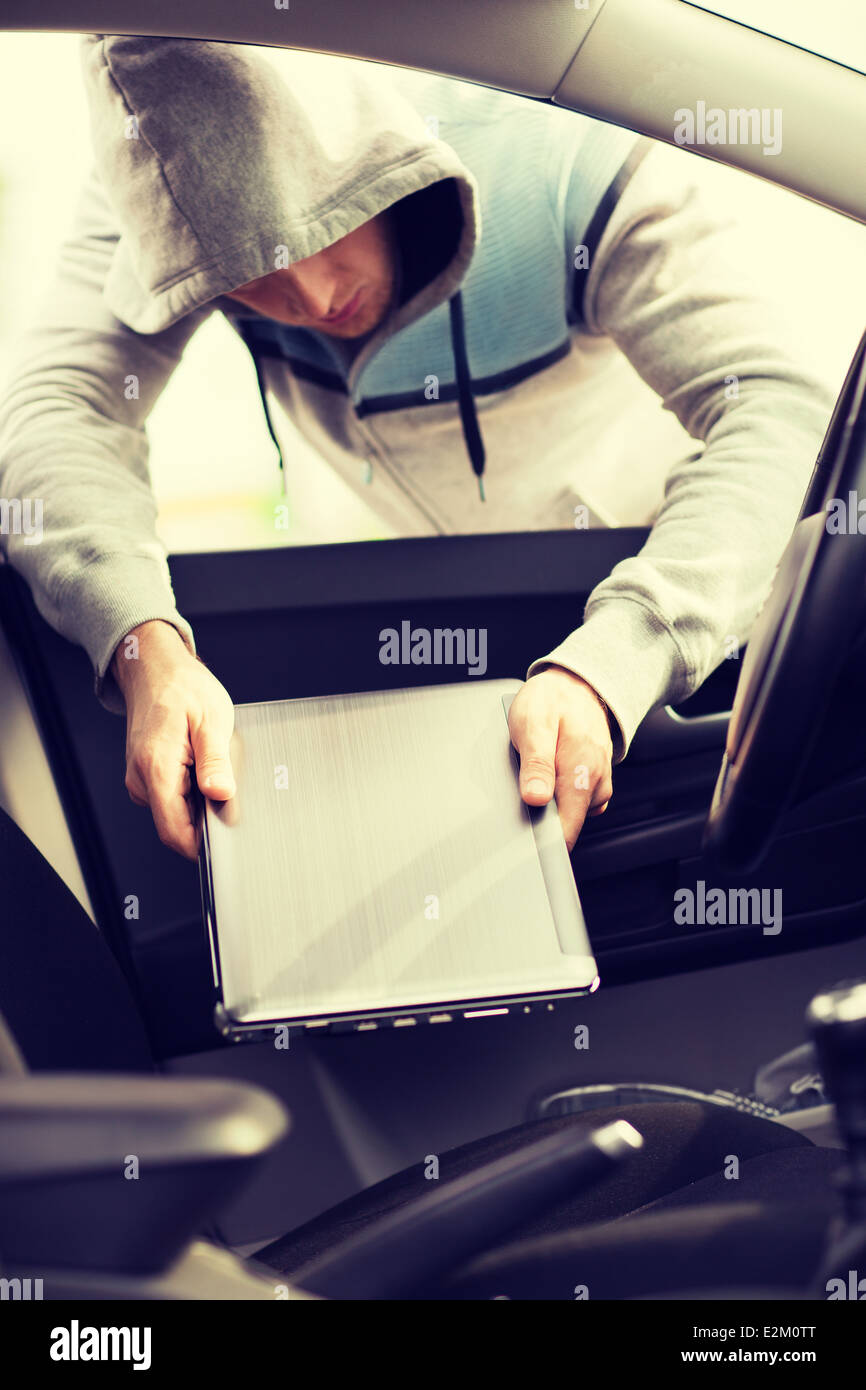 thief stealing laptop from the car Stock Photo - Alamy