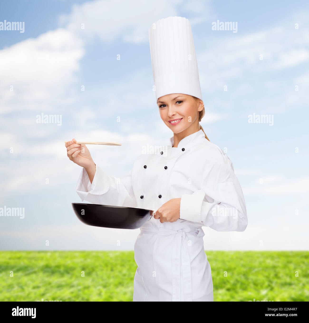 smiling female chef with pan and spoon Stock Photo - Alamy