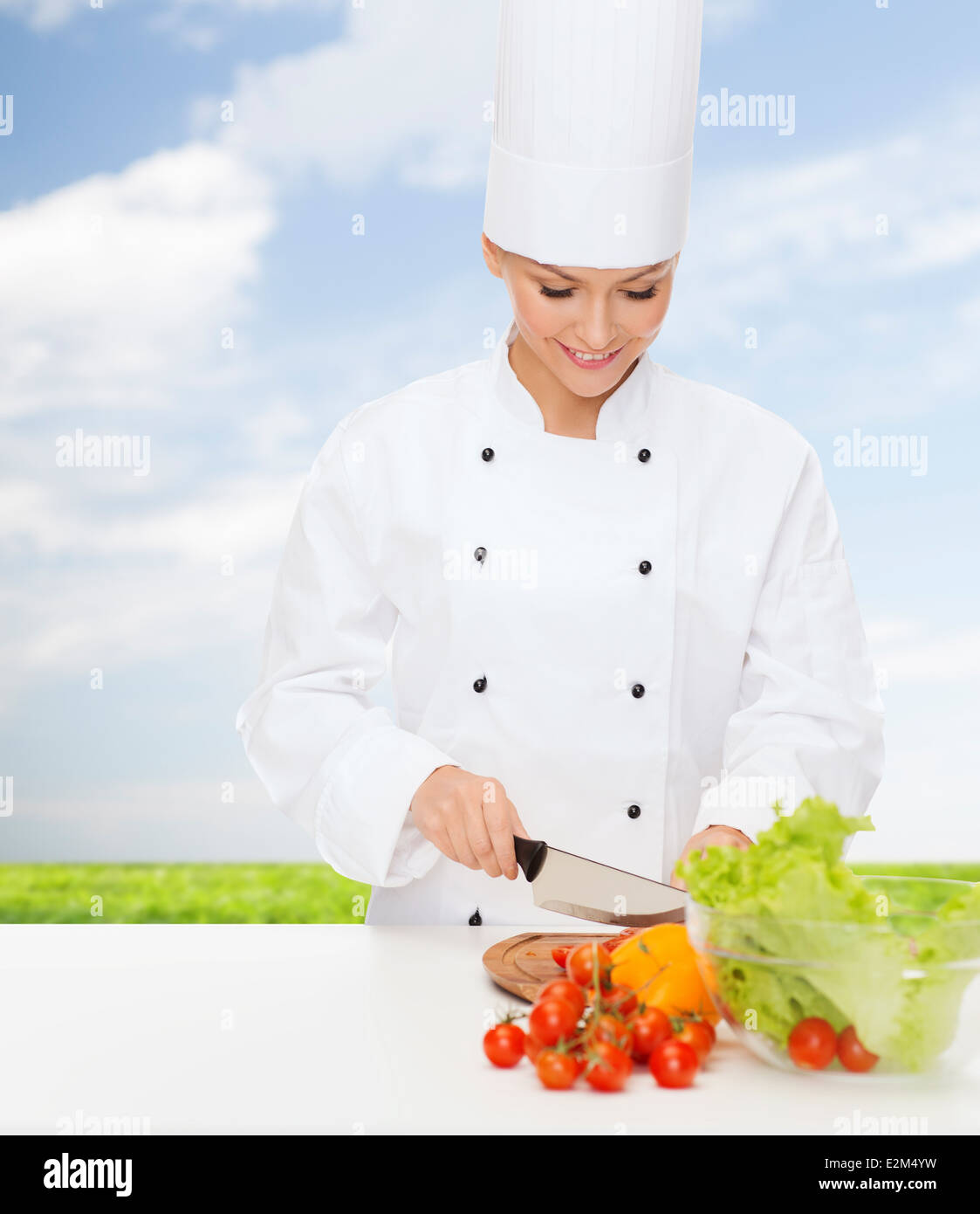 smiling female chef chopping vegetables Stock Photo - Alamy