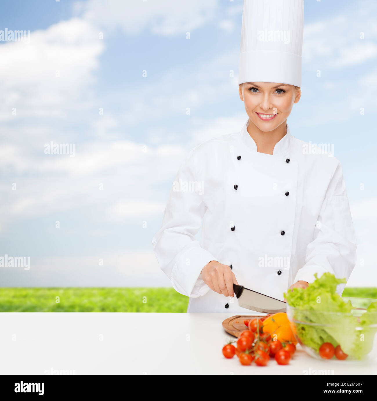 smiling female chef chopping vegetables Stock Photo - Alamy