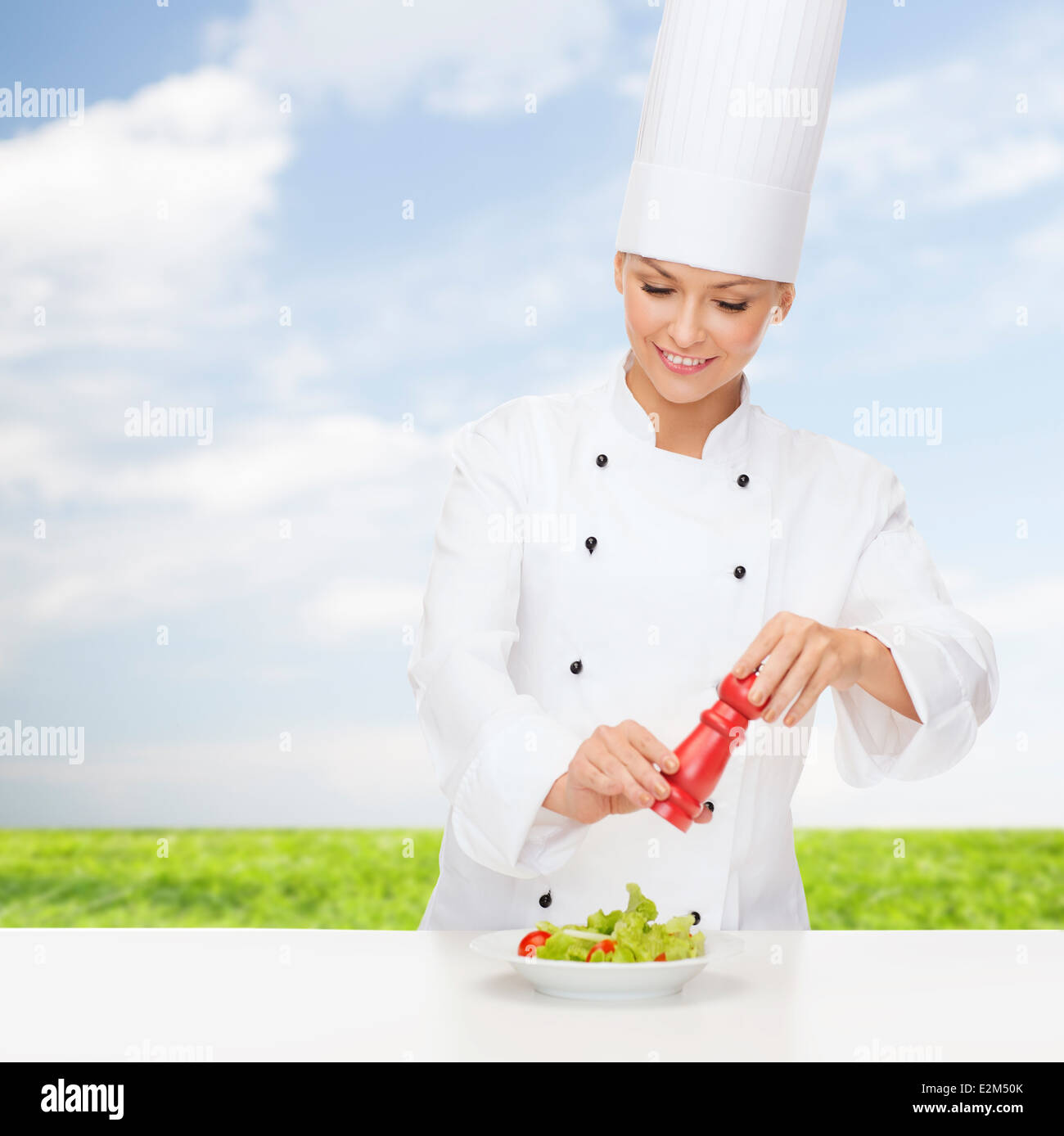 smiling female chef with preparing salad Stock Photo - Alamy