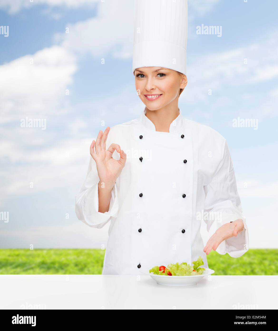 smiling female chef with salad on plate Stock Photo - Alamy