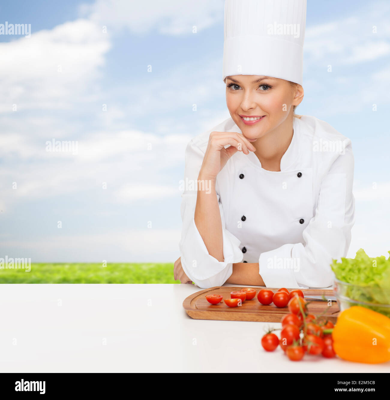 smiling female chef with vegetables Stock Photo - Alamy