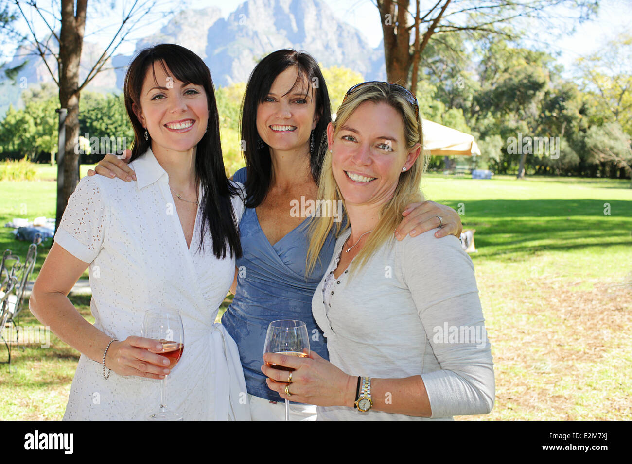 Three strikingly beautiful women enjoying a glass of wine on Mothers ...
