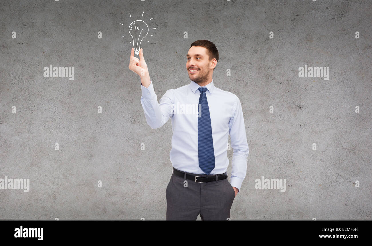handsome businessman holding light bulb Stock Photo - Alamy