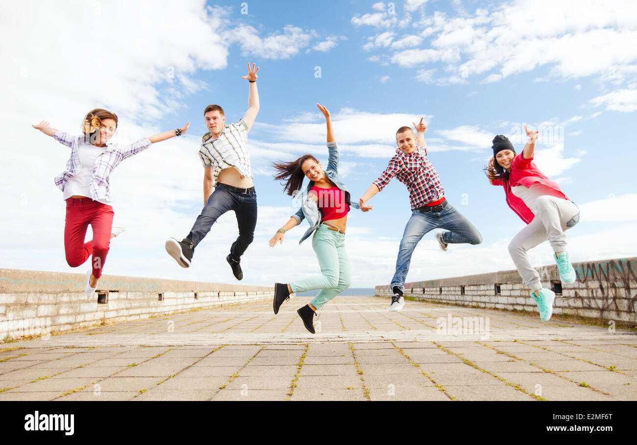 group of teenagers jumping Stock Photo - Alamy