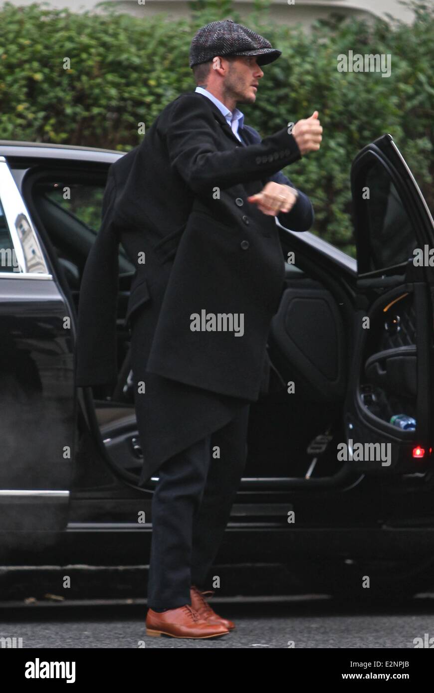 David Beckham parks his Bentley car and puts on a large winter coat as ...