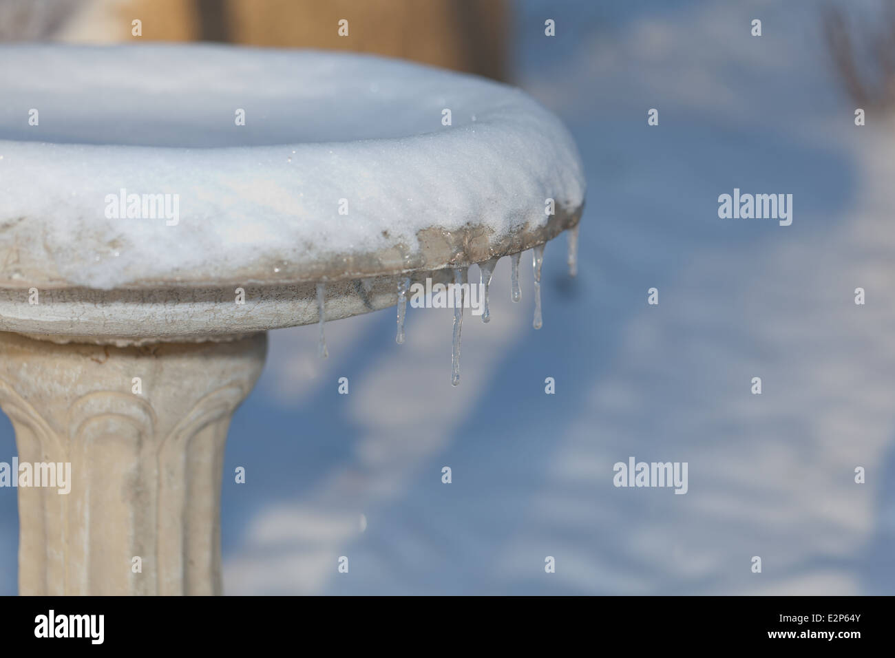 Frozen drips falling from a birdbath Stock Photo - Alamy