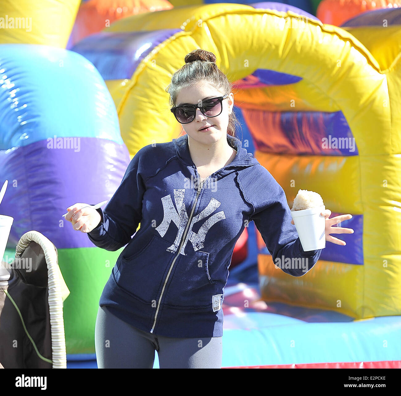 Ariel Winter enjoys an ice cold drink and playing on the bouncy castle ...