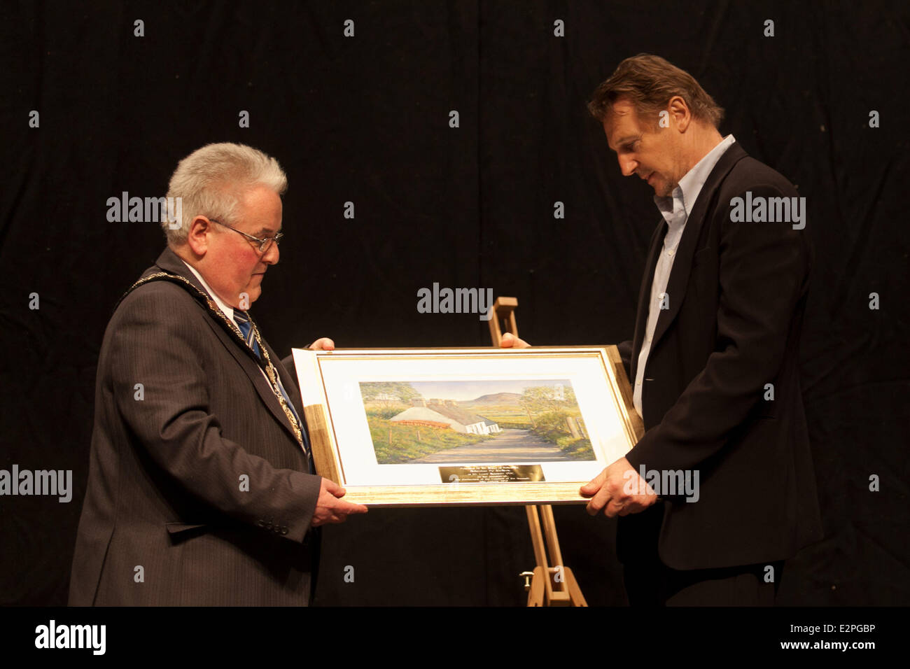 Mayor PJ McAvoy present Liam Neeson with a painting of local landmark ...