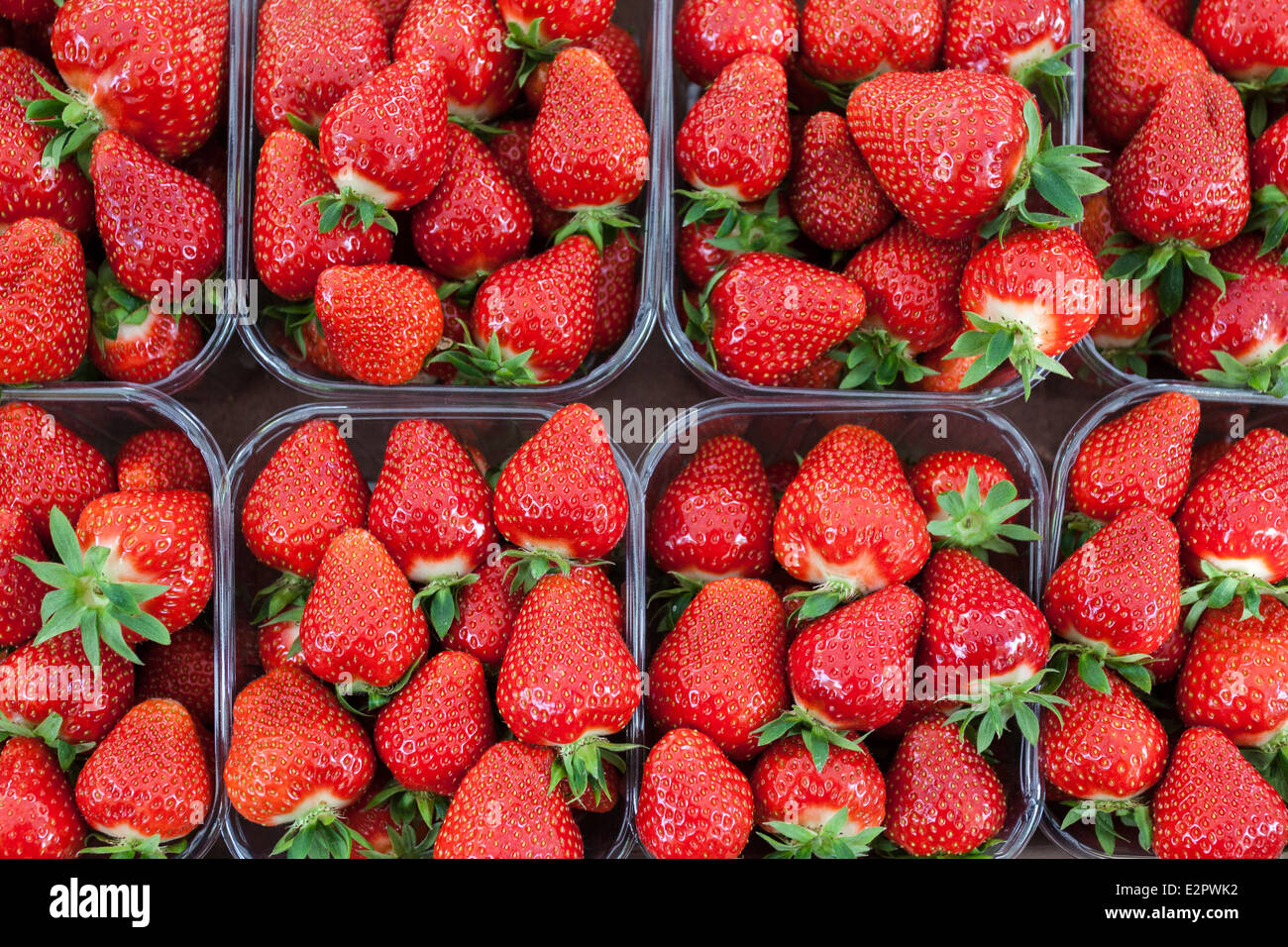 on the market the sell strawberry buckets Stock Photo - Alamy