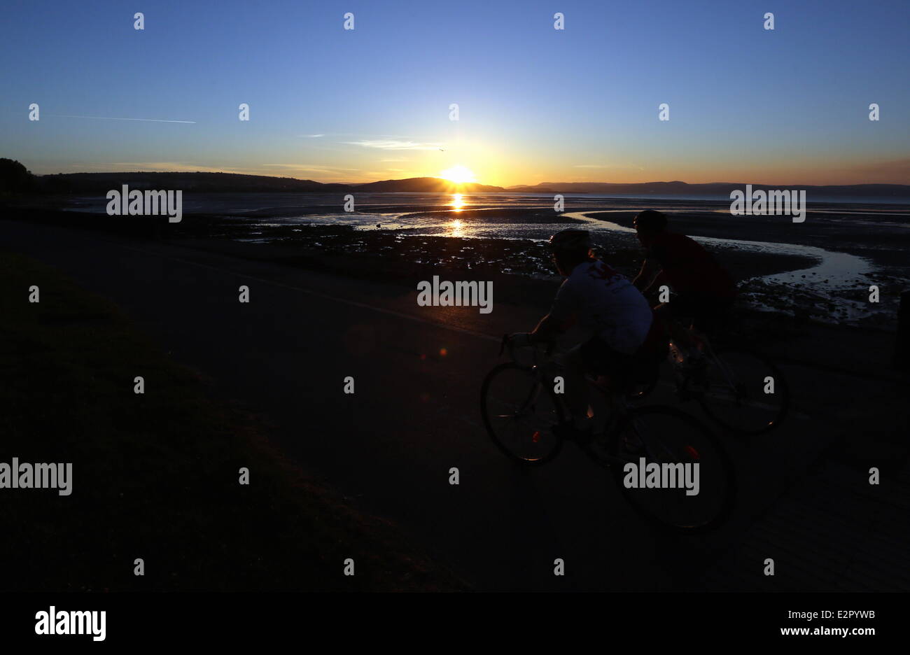 Swansea, UK. Saturday 21 June 2014 Pictured: Two cyclists ride on the ...