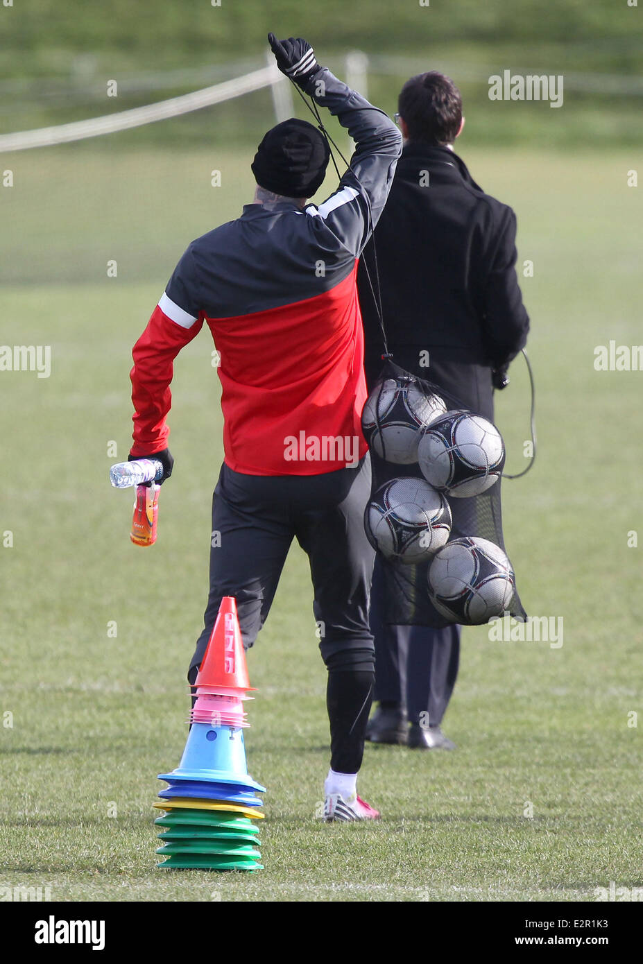 David Beckham walks off the training pitch with a sack of footballs ...