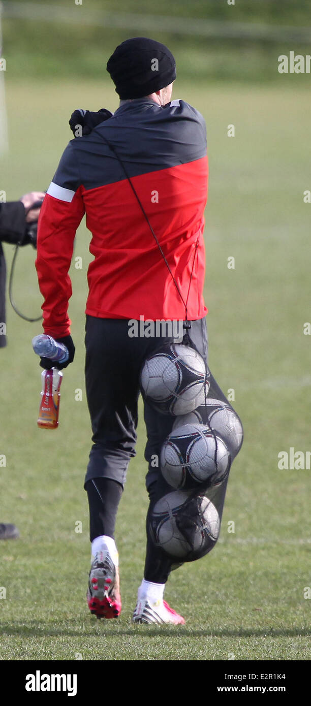 David Beckham walks off the training pitch with a sack of footballs ...