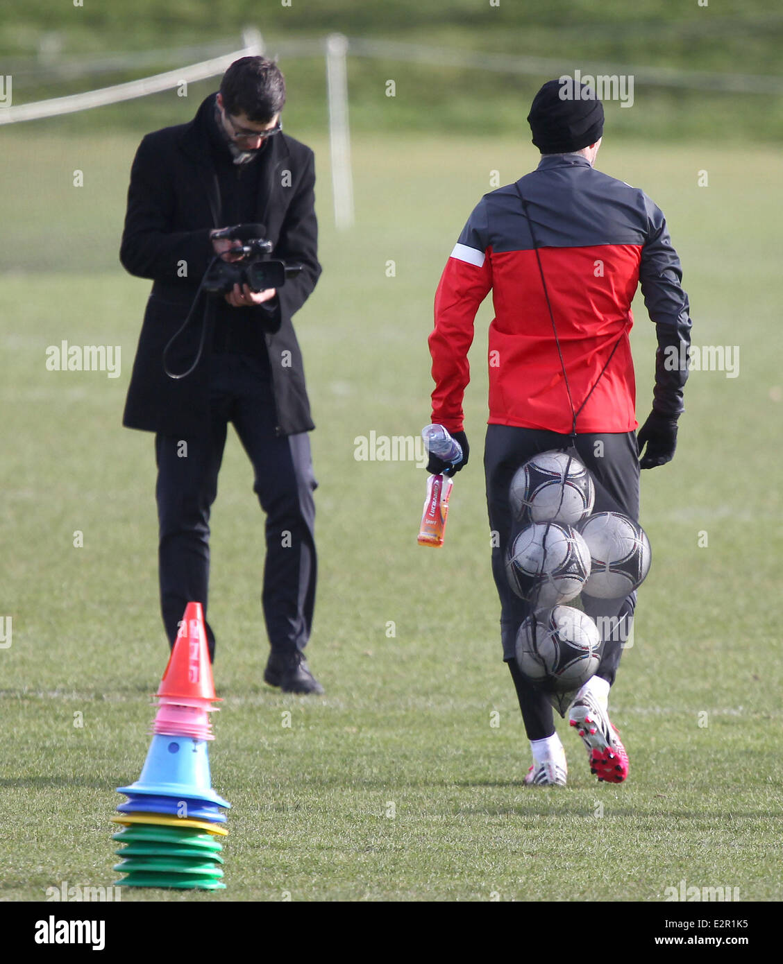 David Beckham walks off the training pitch with a sack of footballs ...