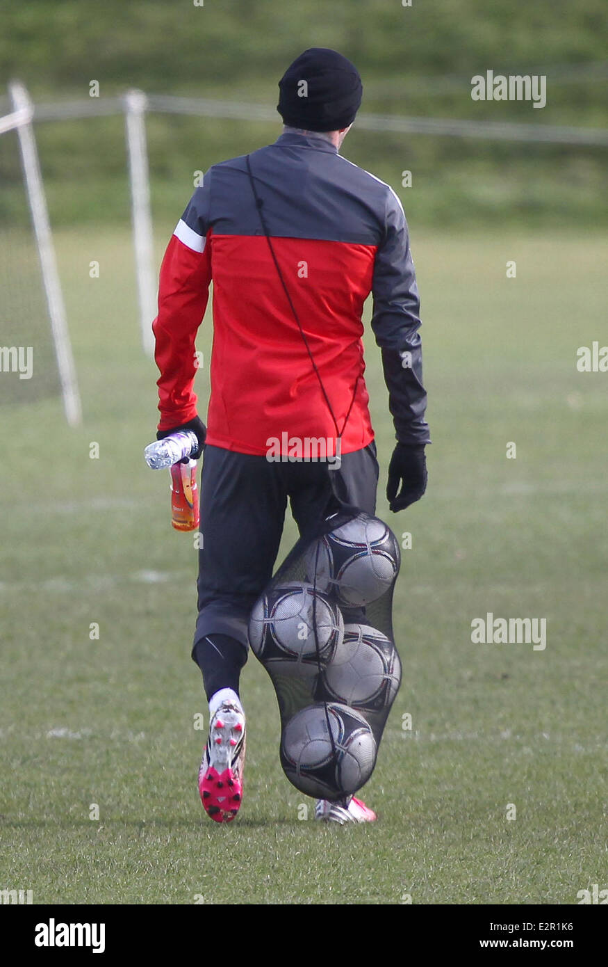 David Beckham walks off the training pitch with a sack of footballs ...