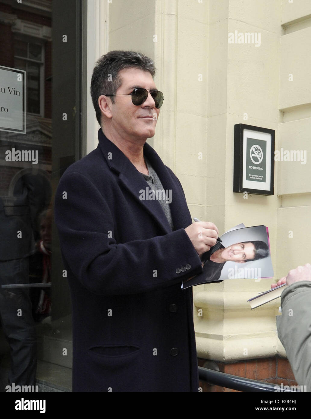 Judges sign autographs for waiting fans as they leave their hotel ...