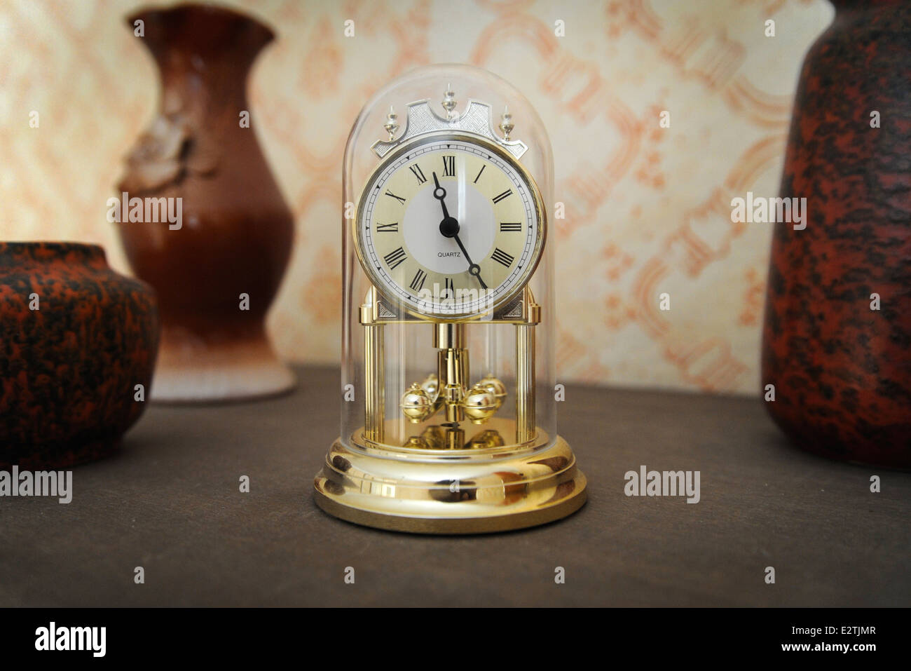 Gold-colored shelf clock Stock Photo - Alamy