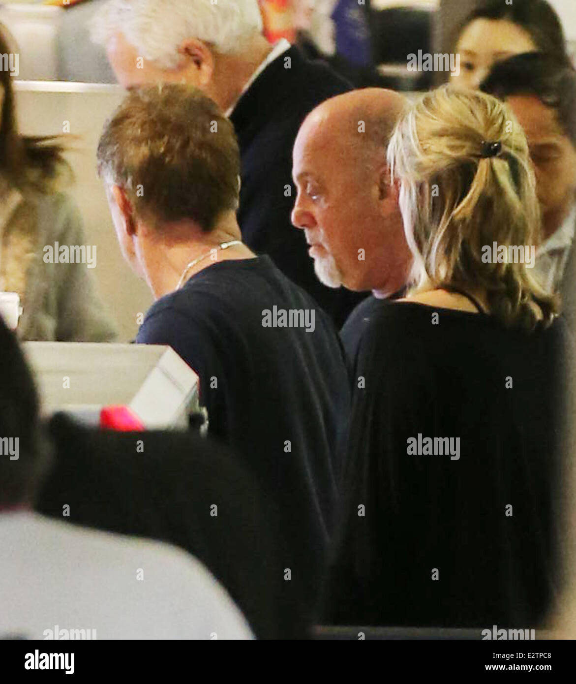 Billy Joel and his wife Alexis Roderick passes through airport security ...