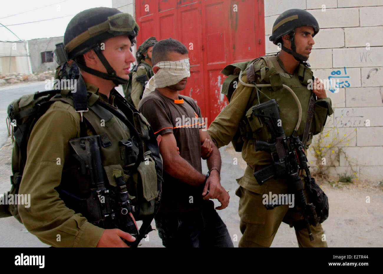 Hebron, West Bank. 21st June, 2014. Israeli soldiers arrest a ...