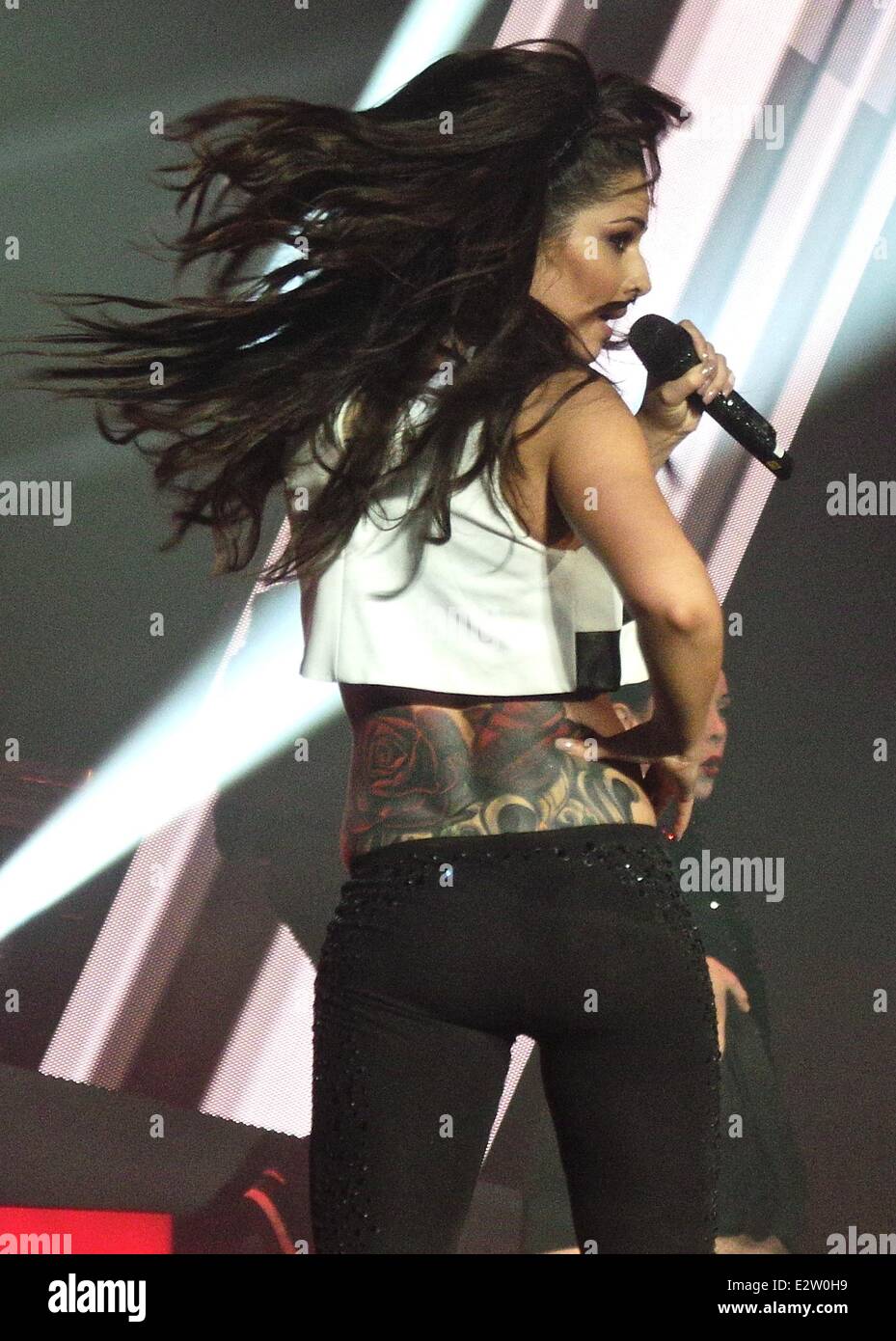 Cheryl Cole shows off her newest back tattoo Girls Aloud performing ...